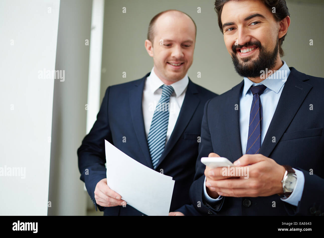 Two friendly businessmen in elegant suits Stock Photo - Alamy