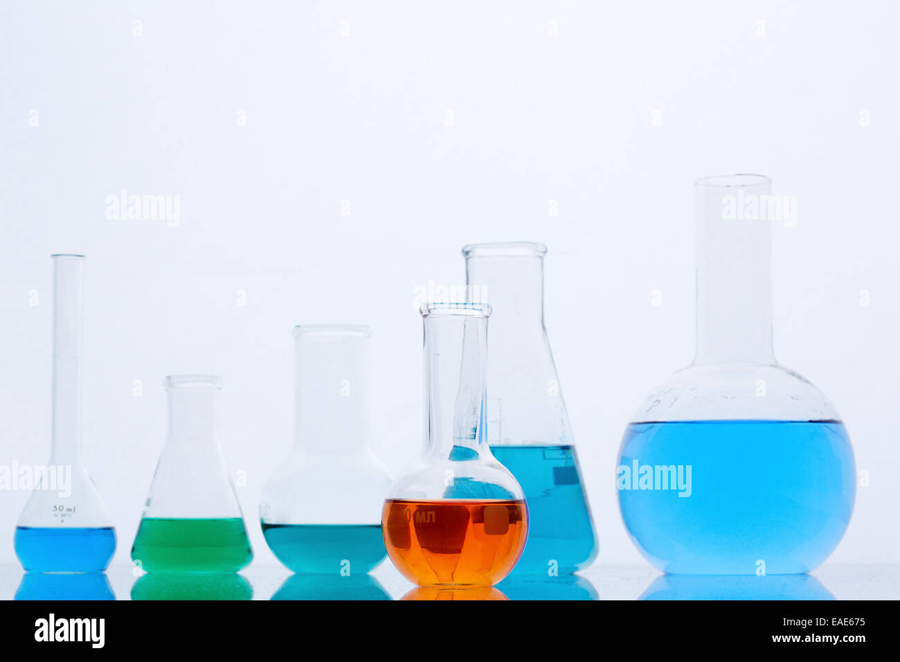 Row of flasks with multi-color liquids in isolation Stock Photo - Alamy Row of flasks with multi-color liquids in isolation Stock Photo - Alamy