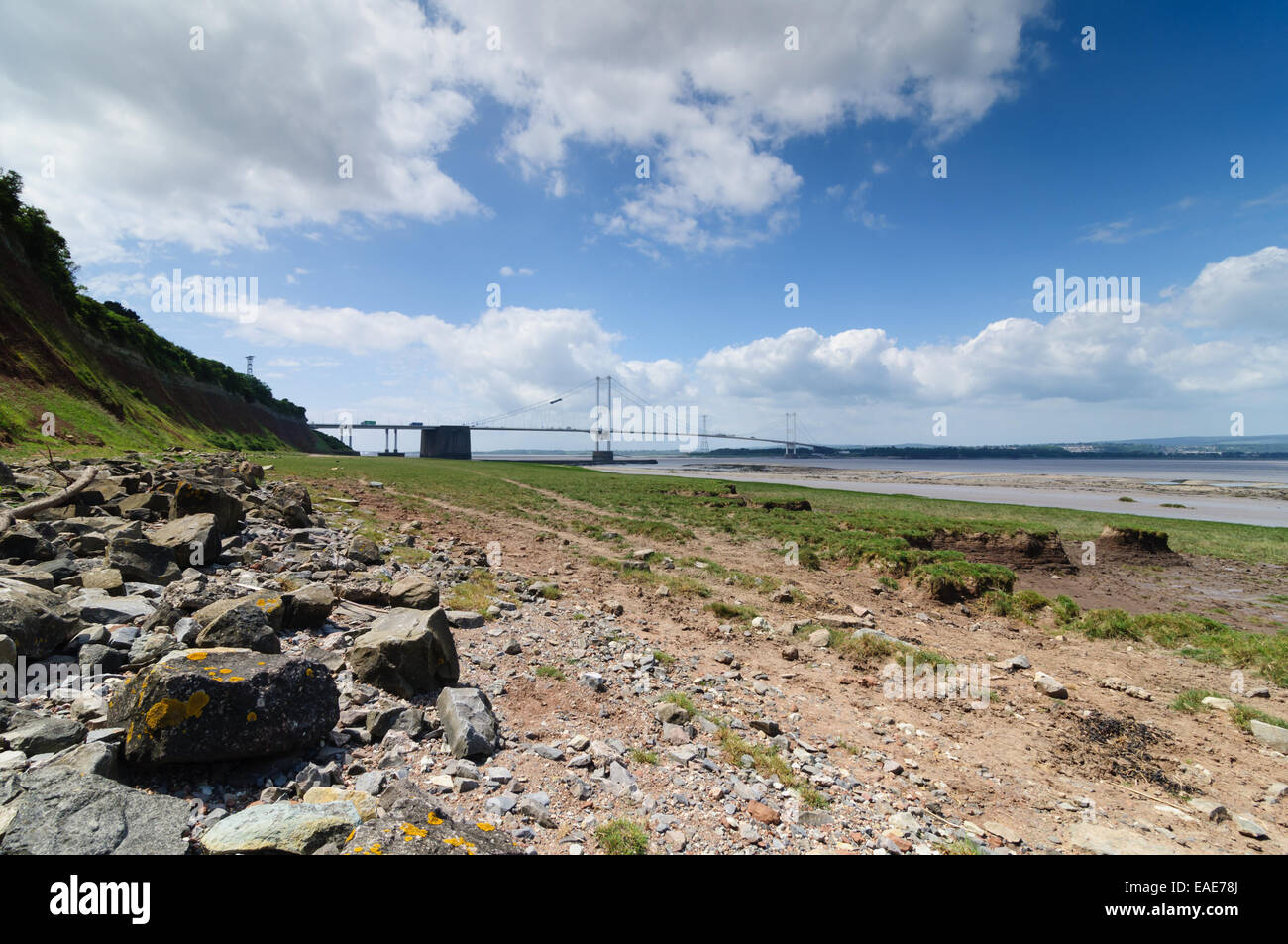 Wide angle view Severn Bridge in background with rocks and shore line ...