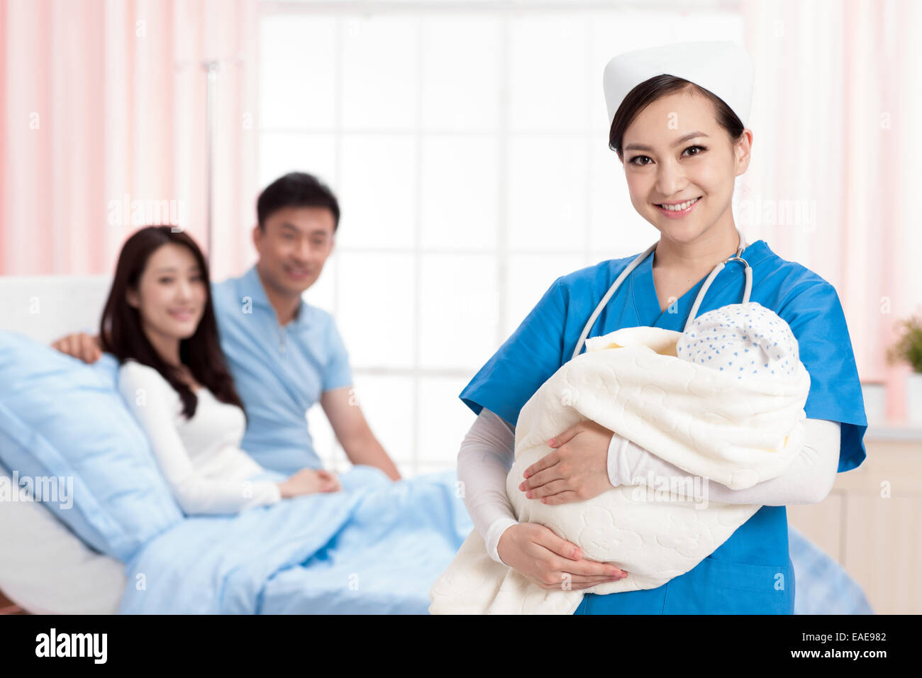 Nurse holding baby hi-res stock photography and images - Alamy