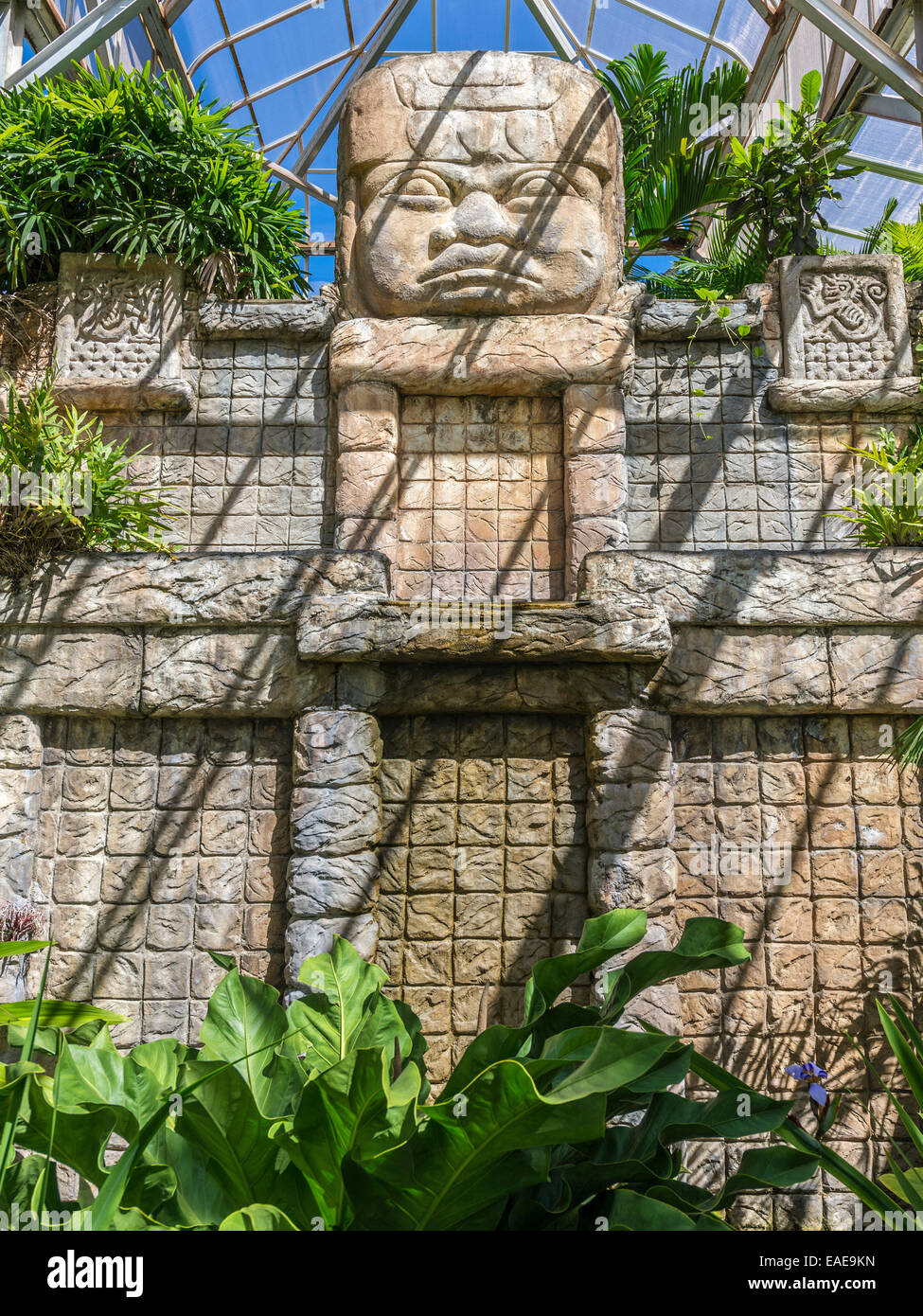 Stone statue providing the focal point in exotic Nevis botanical ...