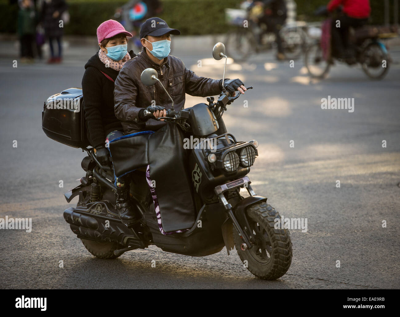 Beijing, China. 13th Nov, 2014. Moped rider wear a respirator against ...