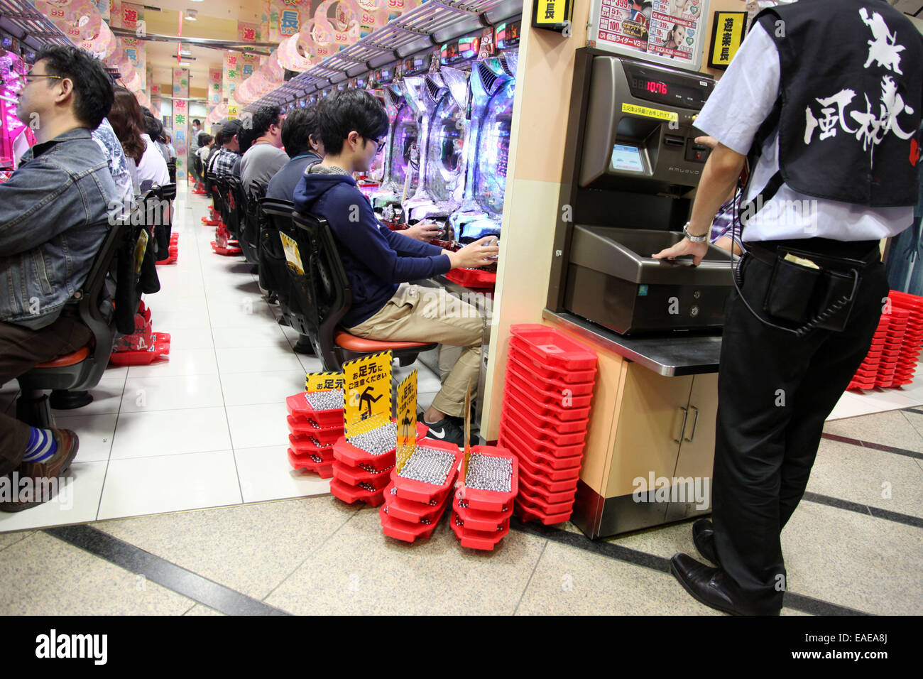 Guests pictured in a pachinko arcade in Tokyo, September 28, 2014 ...