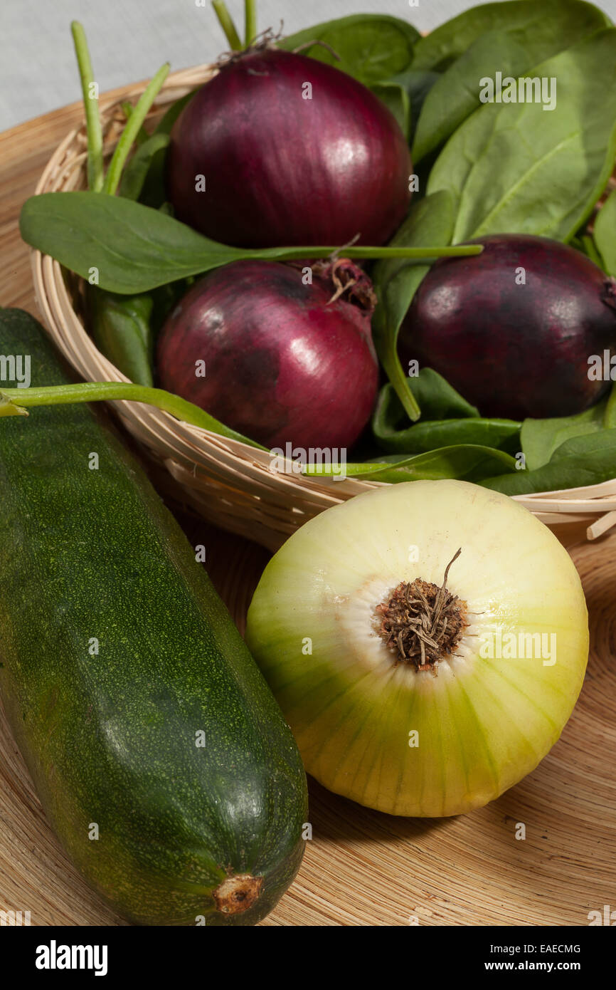 A blend of fresh autumn vegetables: red onions, white onion, zucchini ...