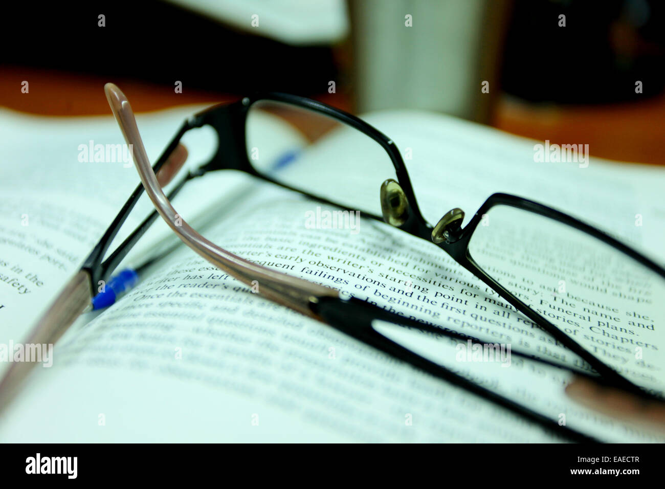 Reading glasses on a book Stock Photo - Alamy