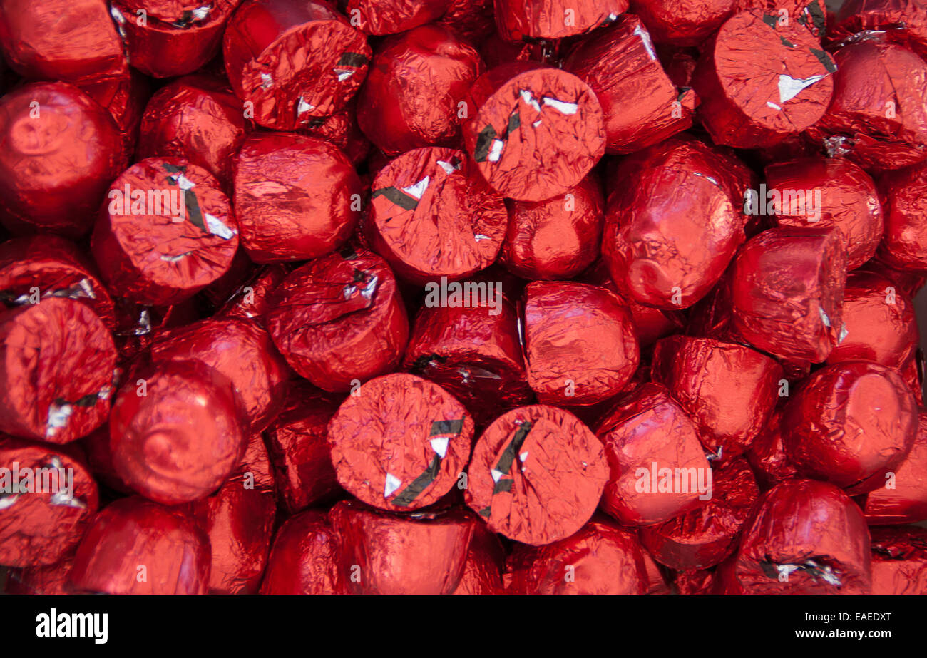 Chocolate in red foil Stock Photo - Alamy
