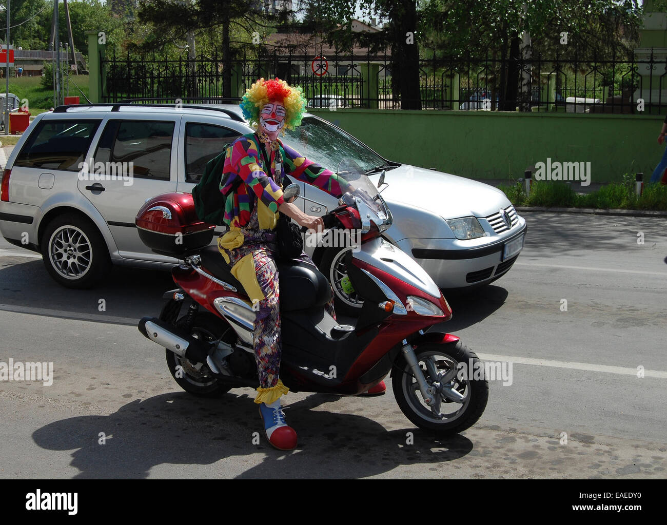Clown who rides a motorcycle through the city and entertains the ...