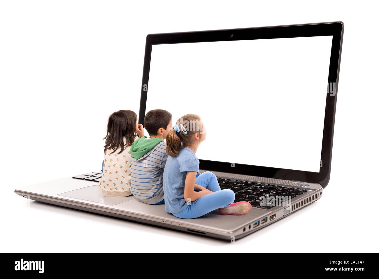 Group of young children in a laptop computer keyboard looking at the ...