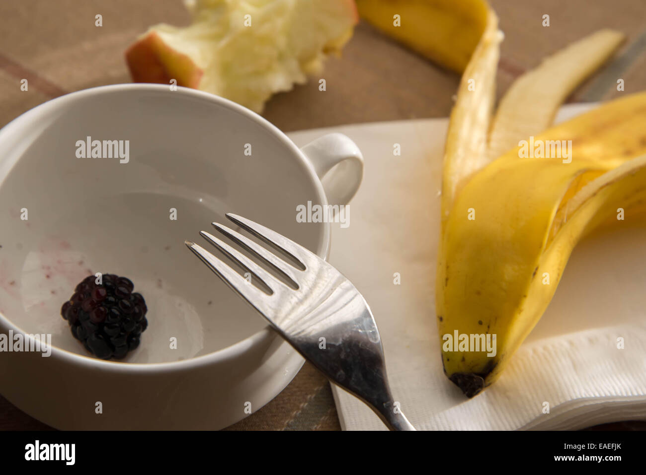 consumed breakfast - empty bowl, banana peel and apple core Stock Photo ...