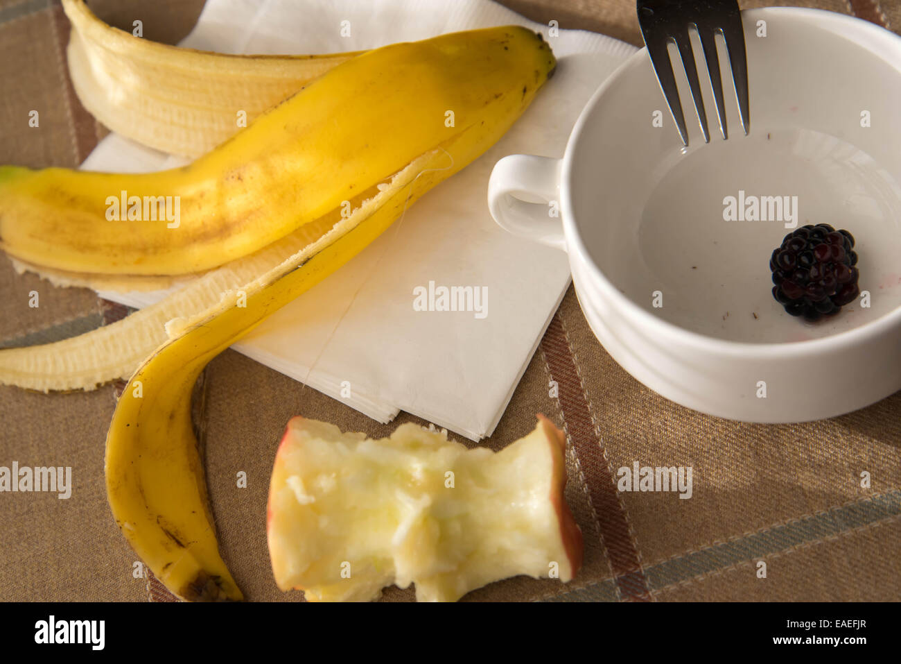 consumed breakfast - empty bowl, banana peel and apple core Stock Photo ...