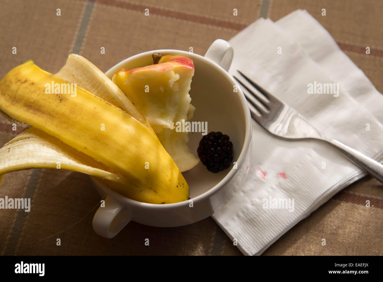 consumed breakfast - empty bowl, banana peel and apple core Stock Photo ...