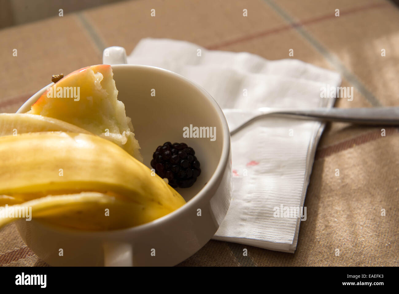 consumed breakfast - empty bowl, banana peel and apple core Stock Photo ...