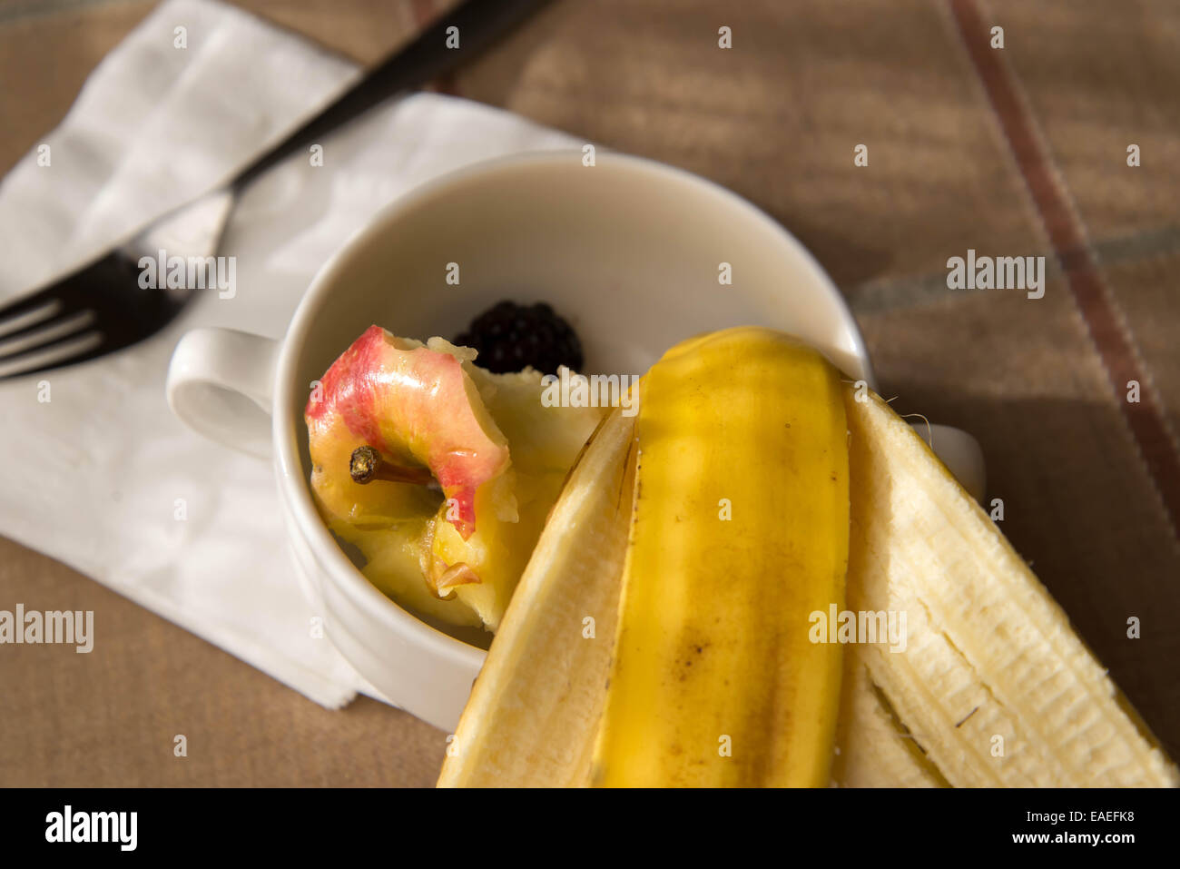 consumed breakfast - empty bowl, banana peel and apple core Stock Photo ...