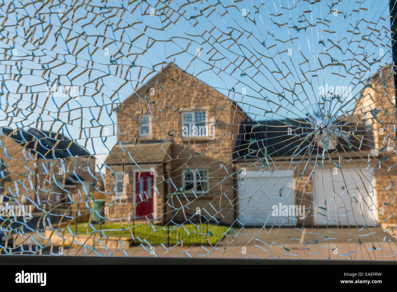 smashed window glass of home under secured premises creating a security ...