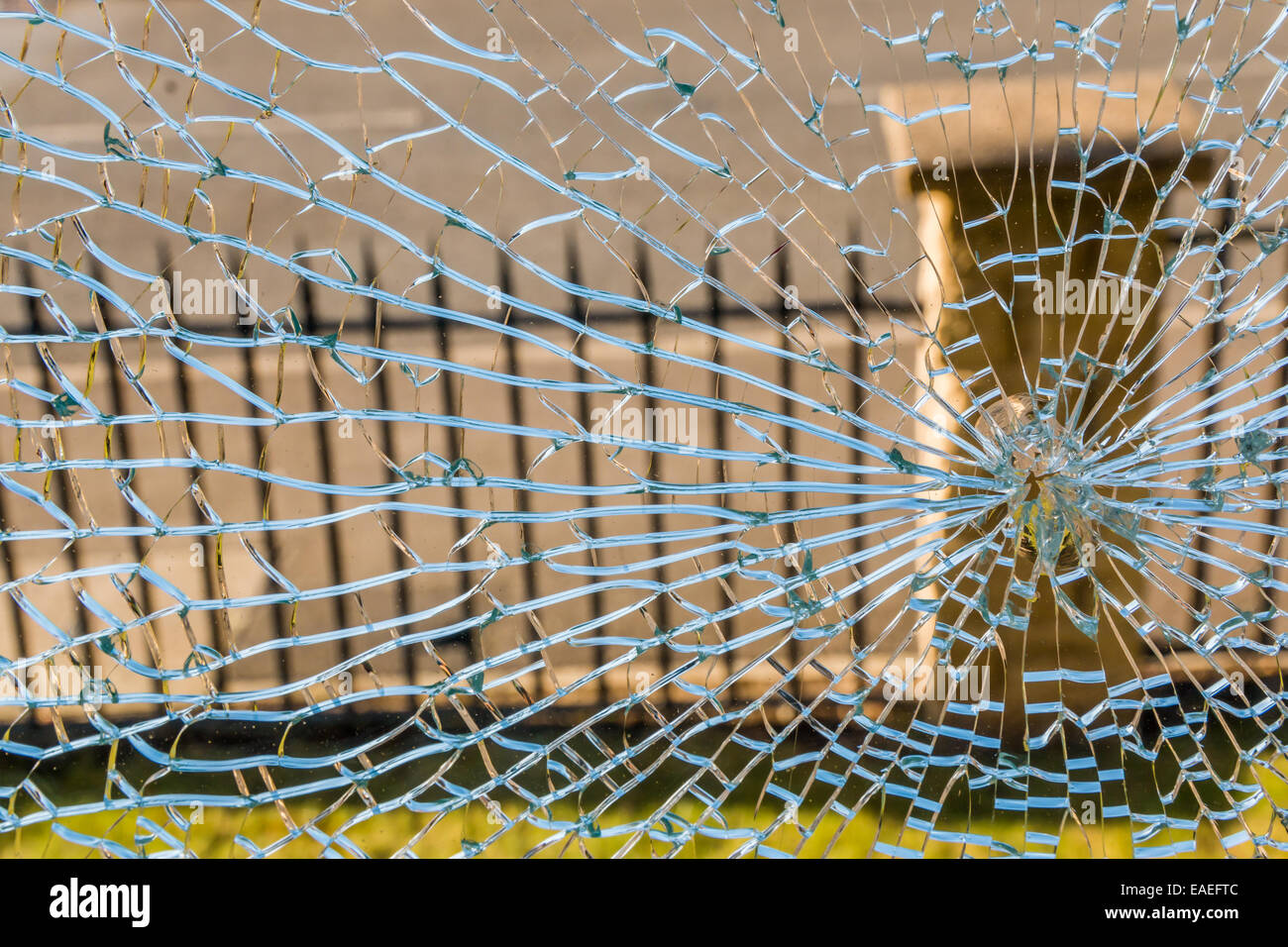 smashed window glass of home under secured premises creating a security ...