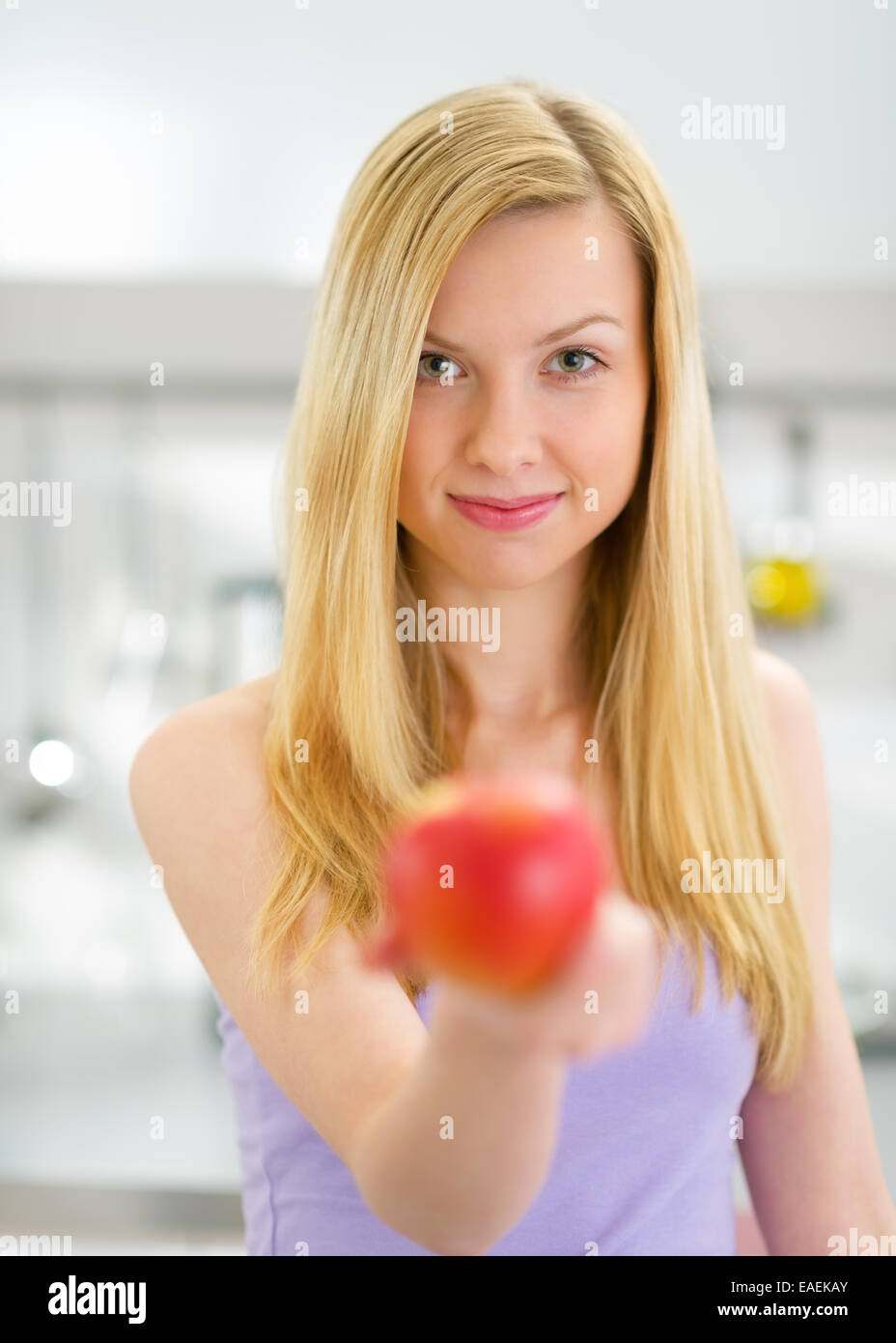 Young woman giving apple Stock Photo - Alamy
