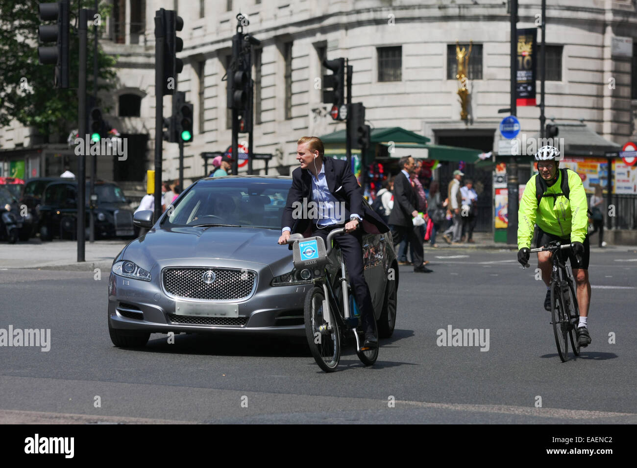 Cyclists and a car traveling around London,s Trafalgar Square Stock ...