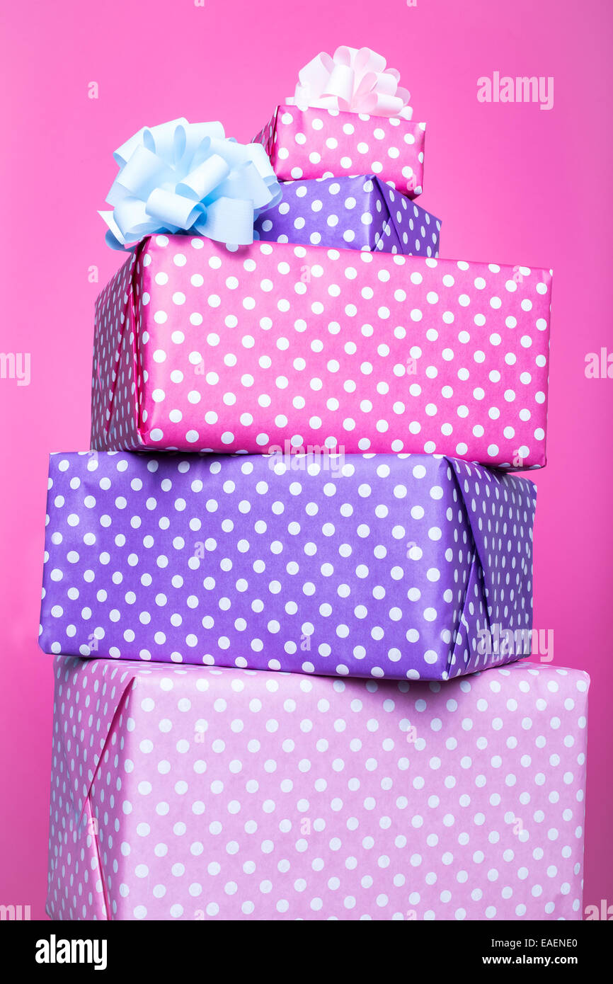 Colorful gift boxes with ribbon over pink background. Pink, purple ...