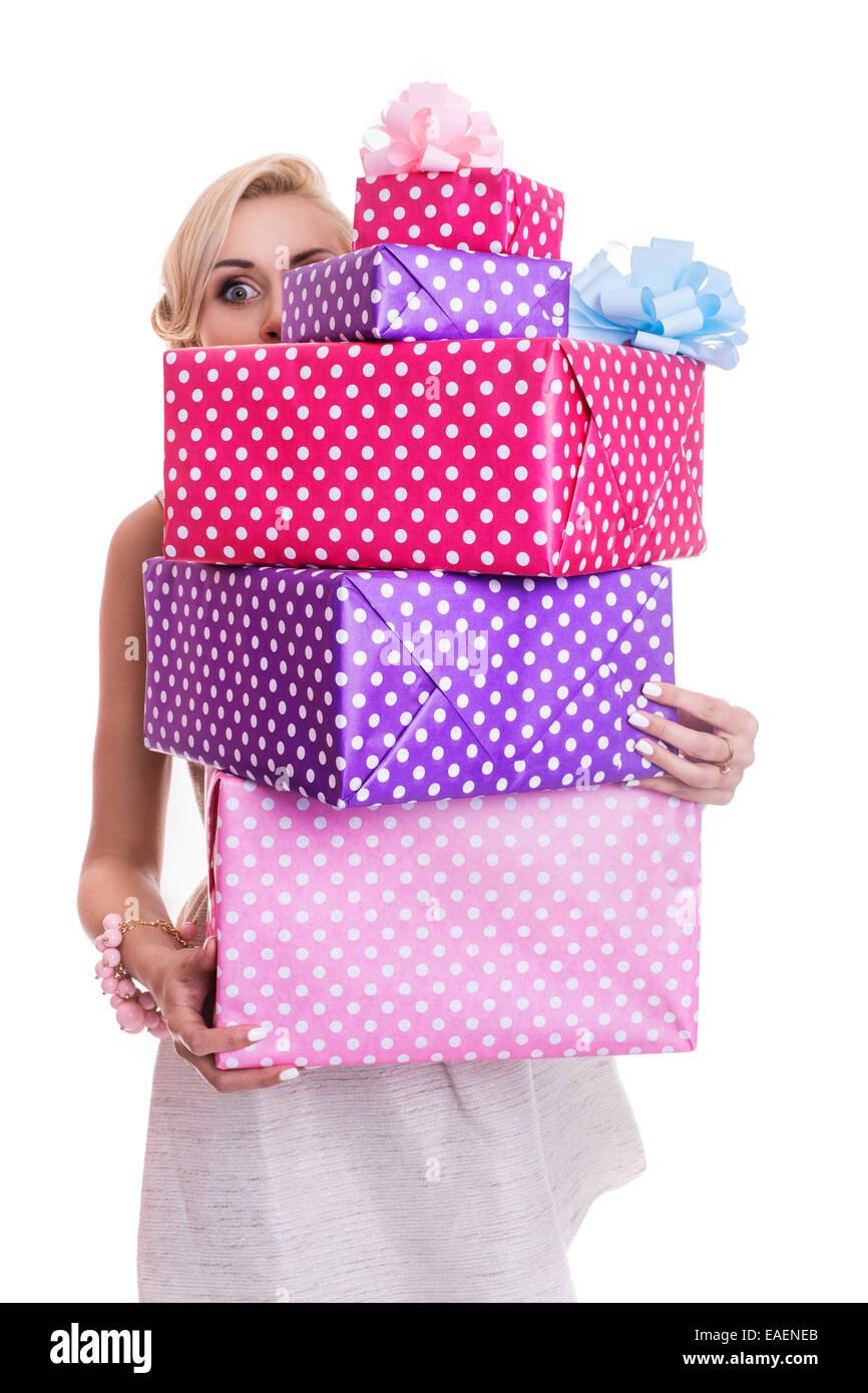 Beautiful blonde woman looking through colorful gift boxes. Studio ...