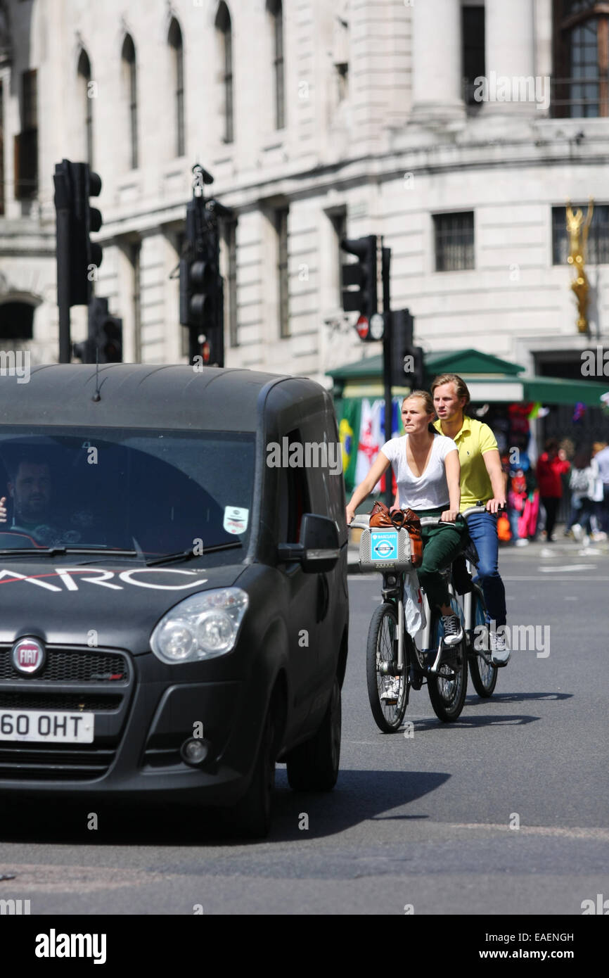 Cyclists traveling behind a van in London's Trafalgar Square Stock ...