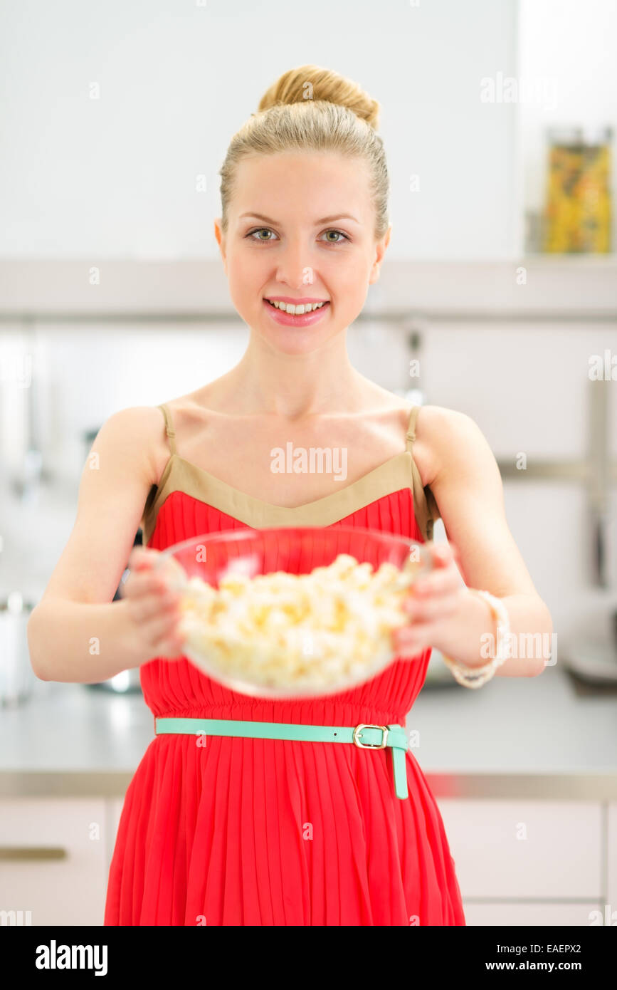 Young woman giving popcorn Stock Photo - Alamy
