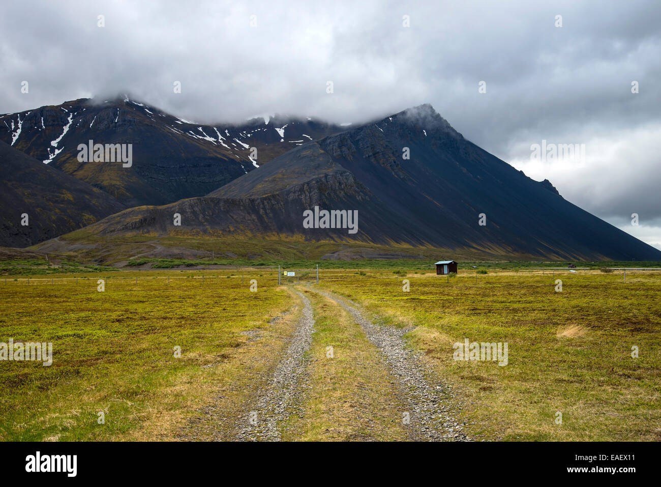 Rugged Icelandic landscape with an isolated path leading to a dark ...