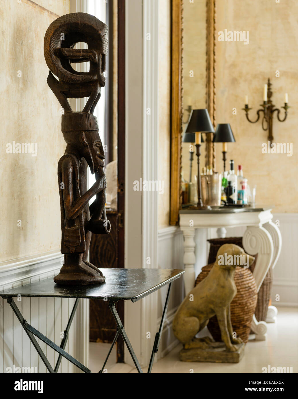 Rare African Mende carving on metal cafe table. A baroque-style painted ...