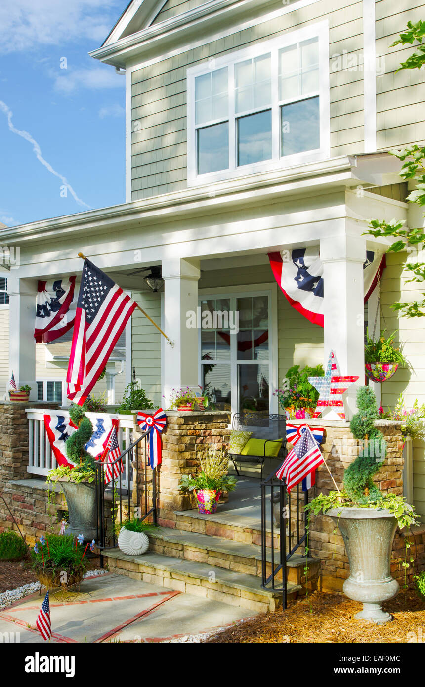 An American Flag and buntings hang from a front porch of an upscale ...