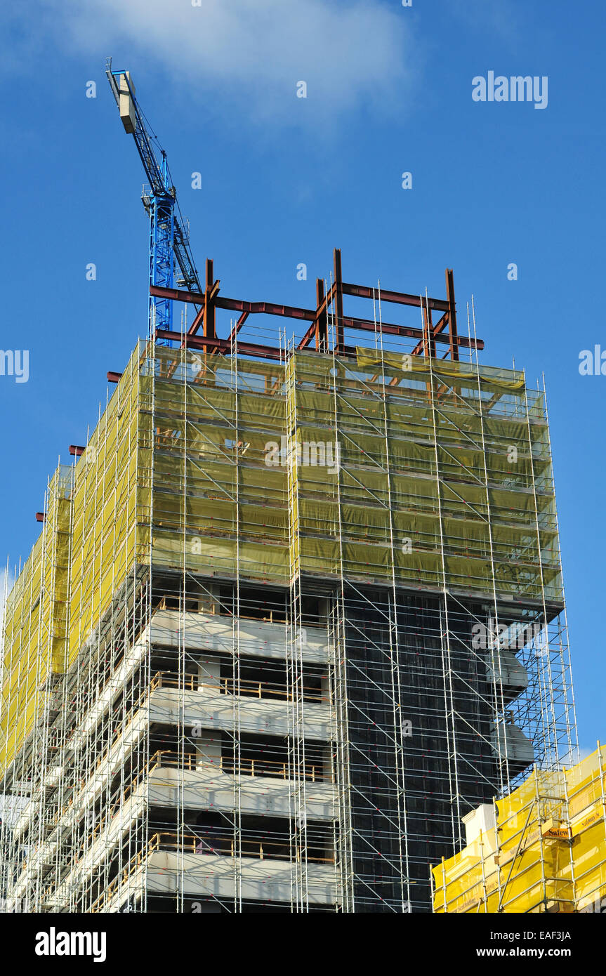 Construction site of tall administration building with crane ...