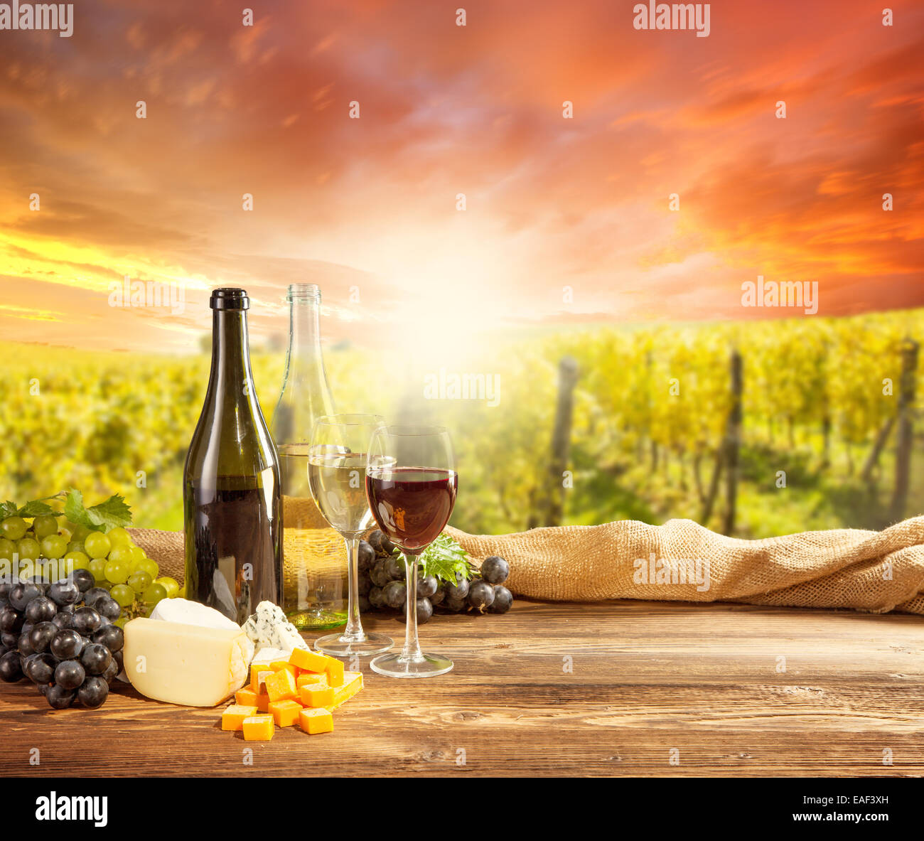 Wine still life with bottle and glass of red wine. Rural vineyard on ...