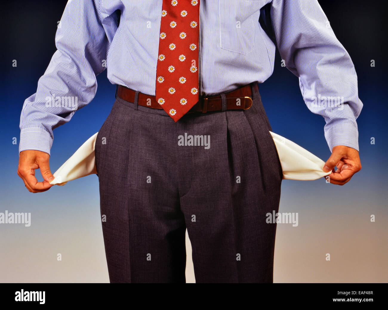 Mann shows empty pockets Stock Photo - Alamy