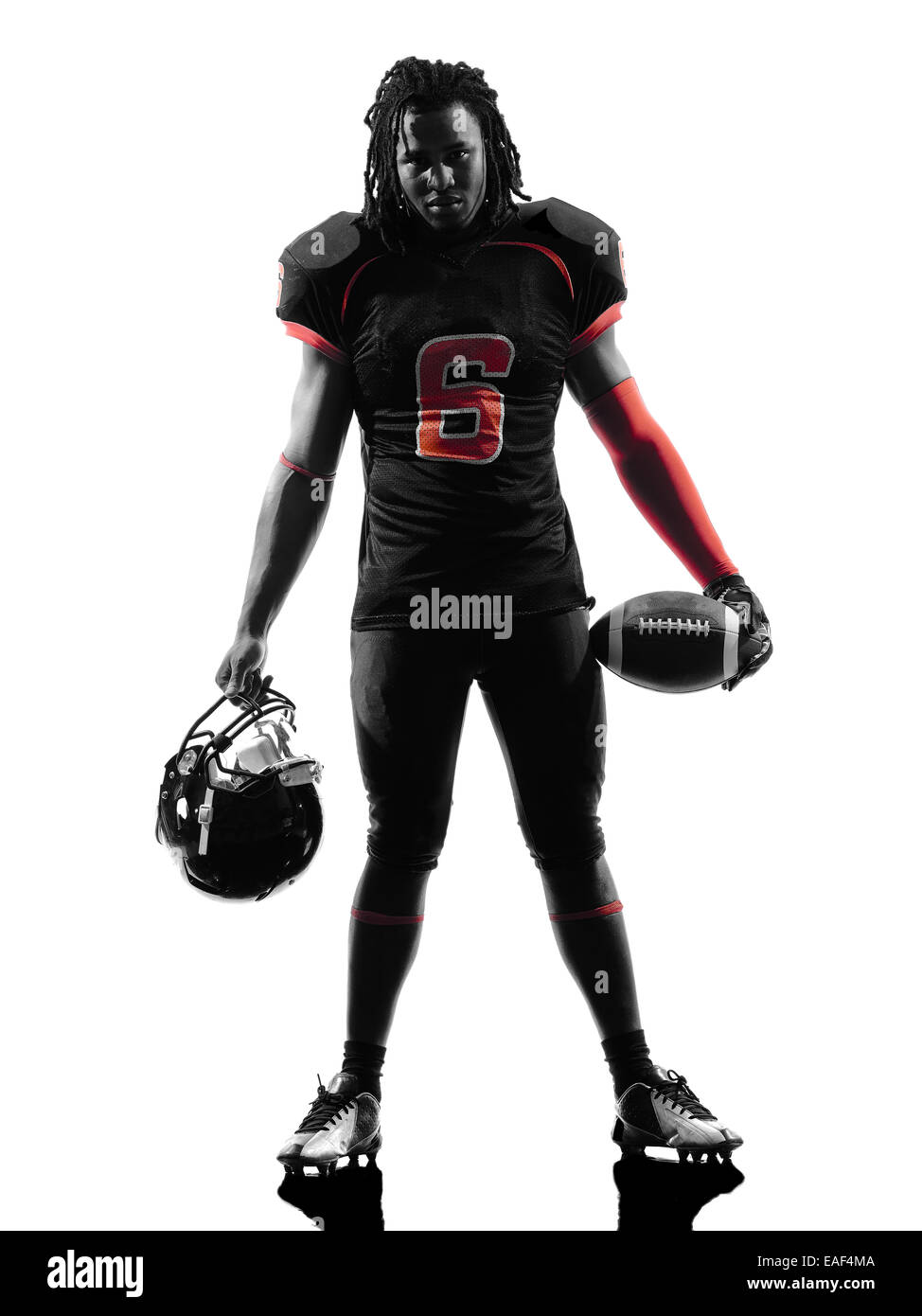 one american football player standing in silhouette shadow on white ...