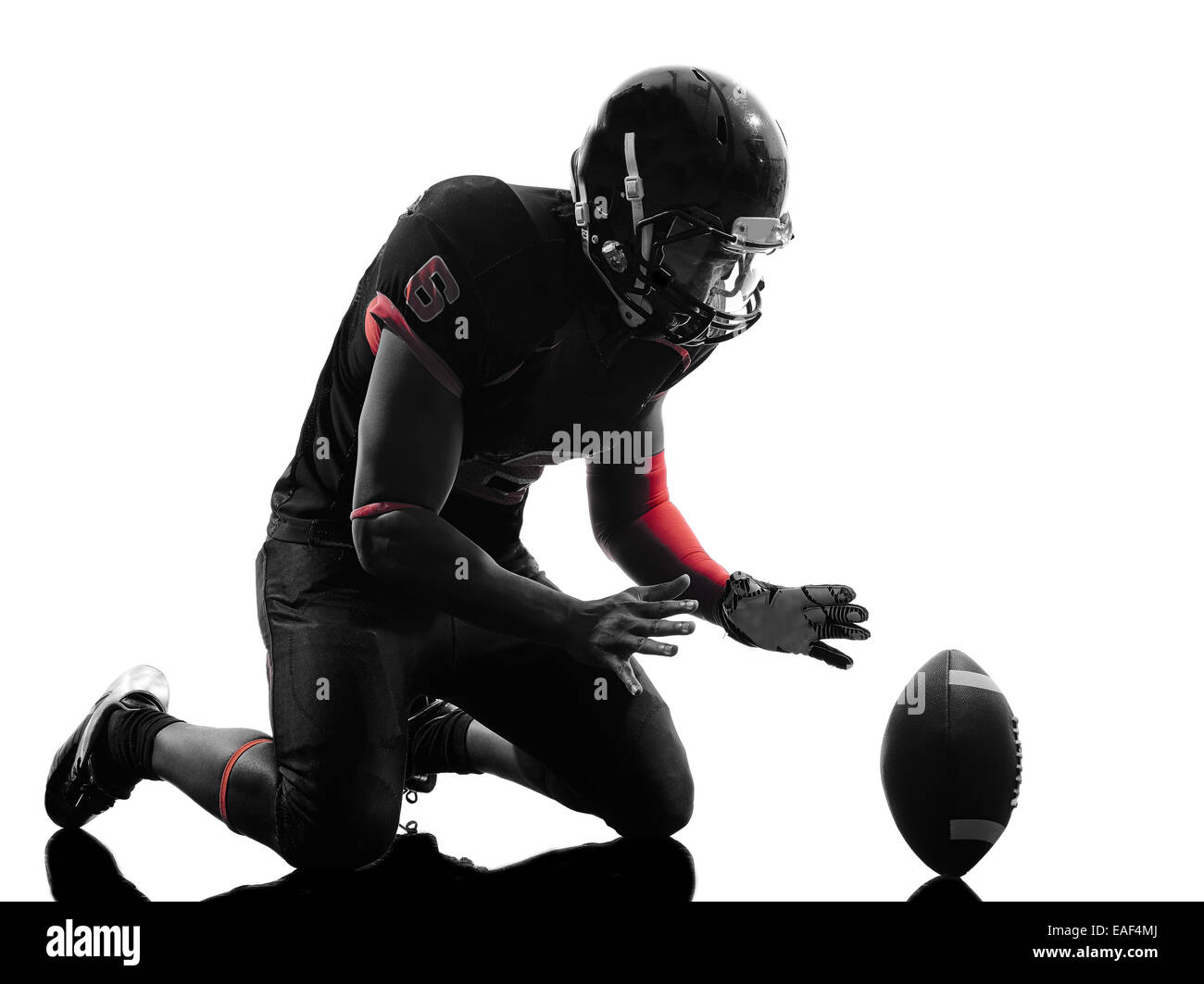 one american football player touchdown celebration in silhouette shadow ...