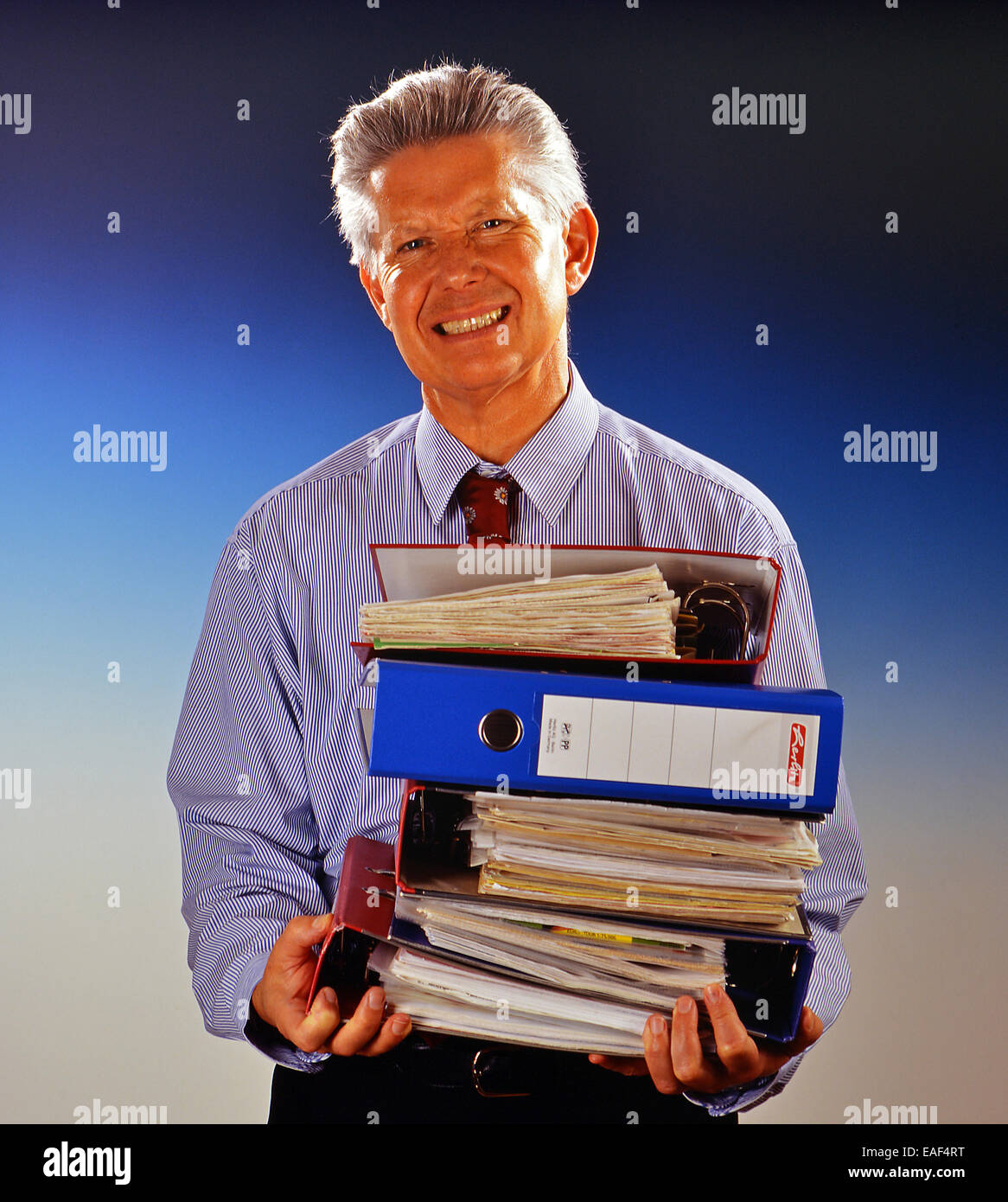 Man with many heavy file folders Stock Photo - Alamy