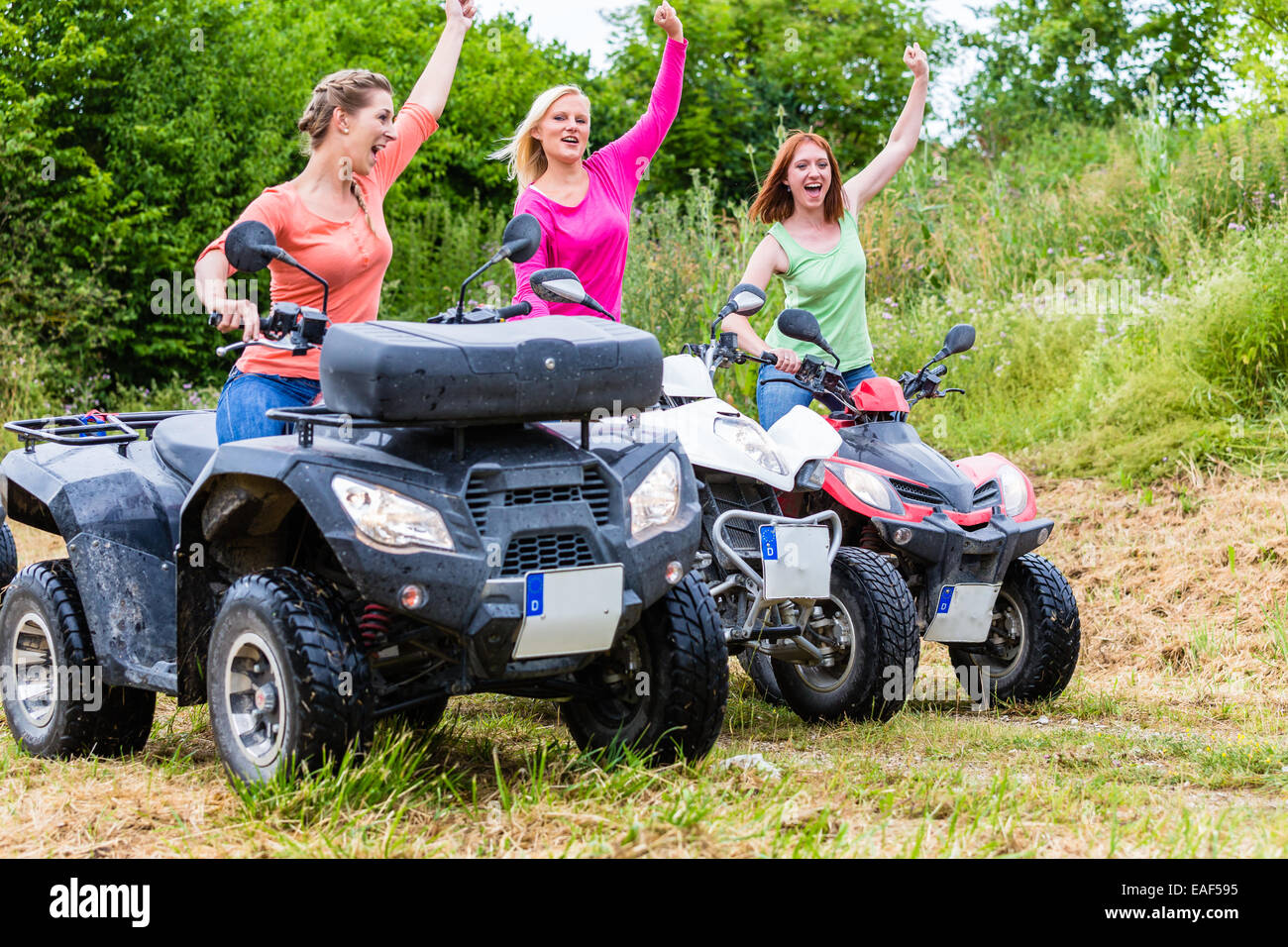 Friends driving off-road with quad bike or ATV Stock Photo - Alamy
