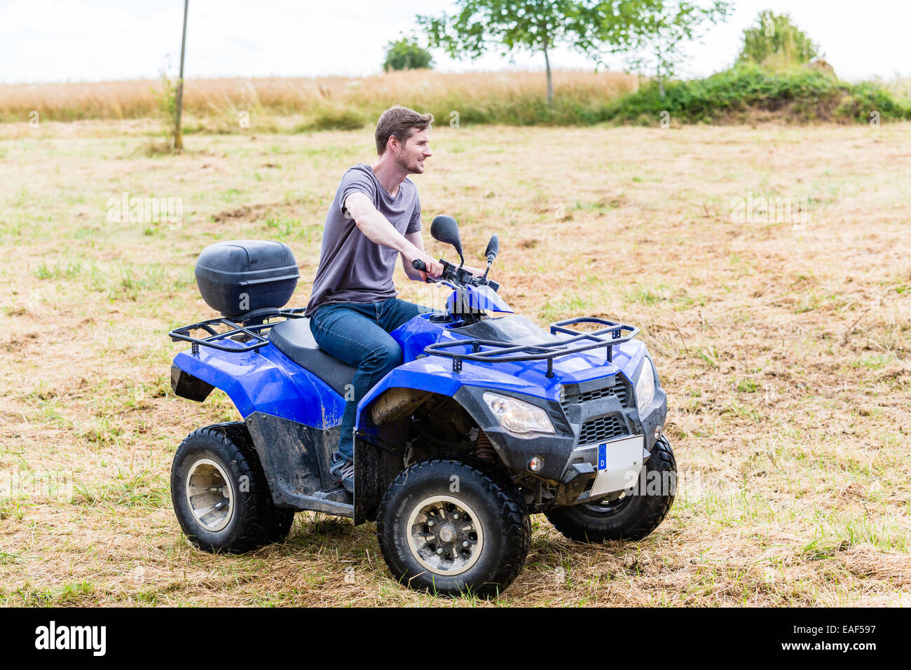 Man driving off-road with quad bike or ATV Stock Photo - Alamy