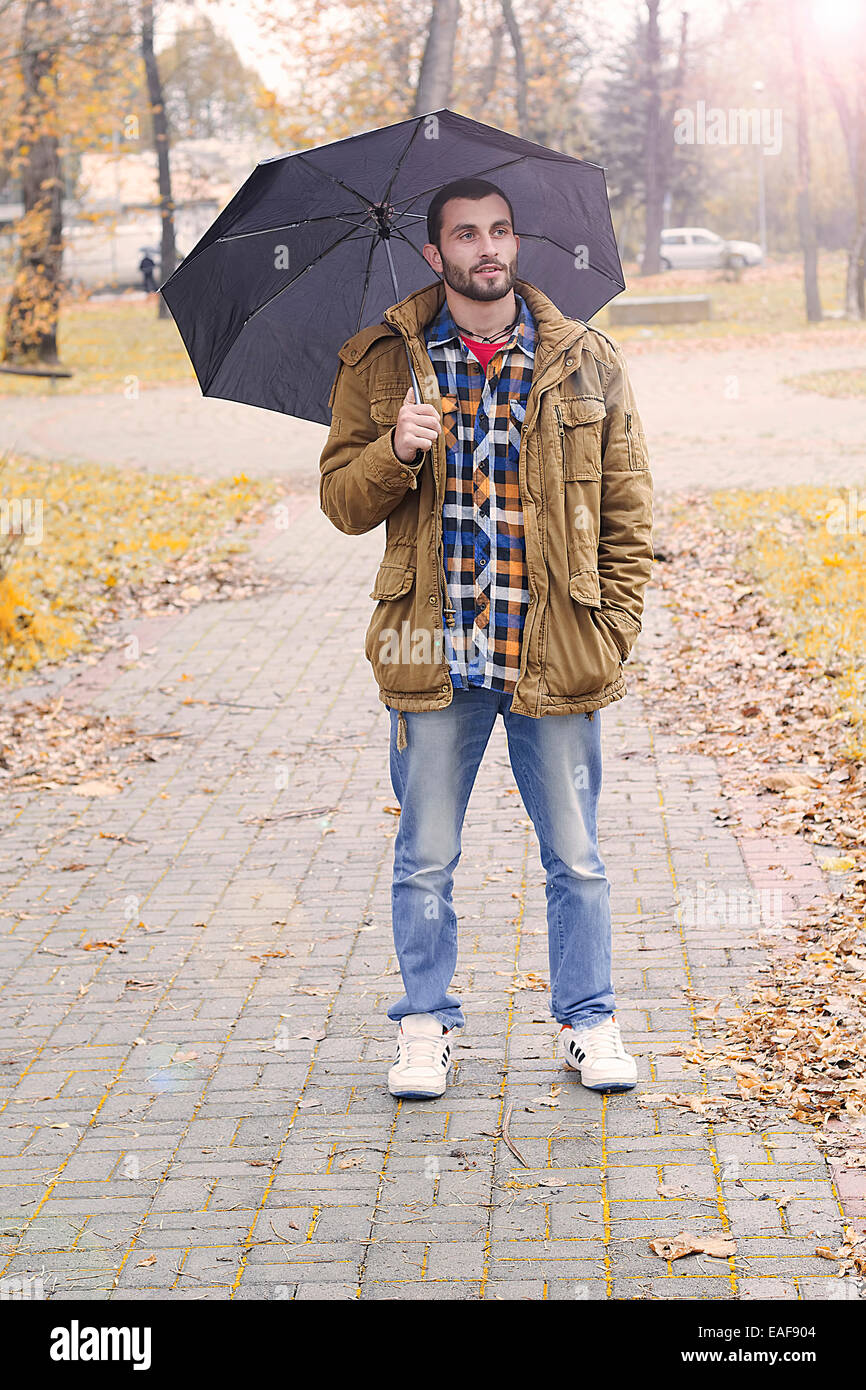 Man holding umbrella Stock Photo - Alamy
