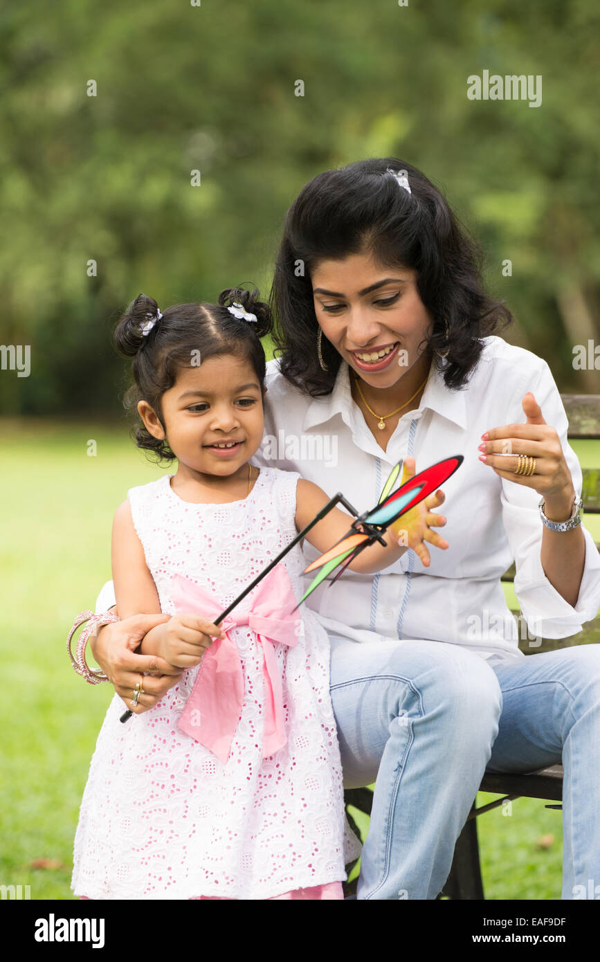 Happy Indian Mother And Daughter Playing In The Park Lifestyle Image