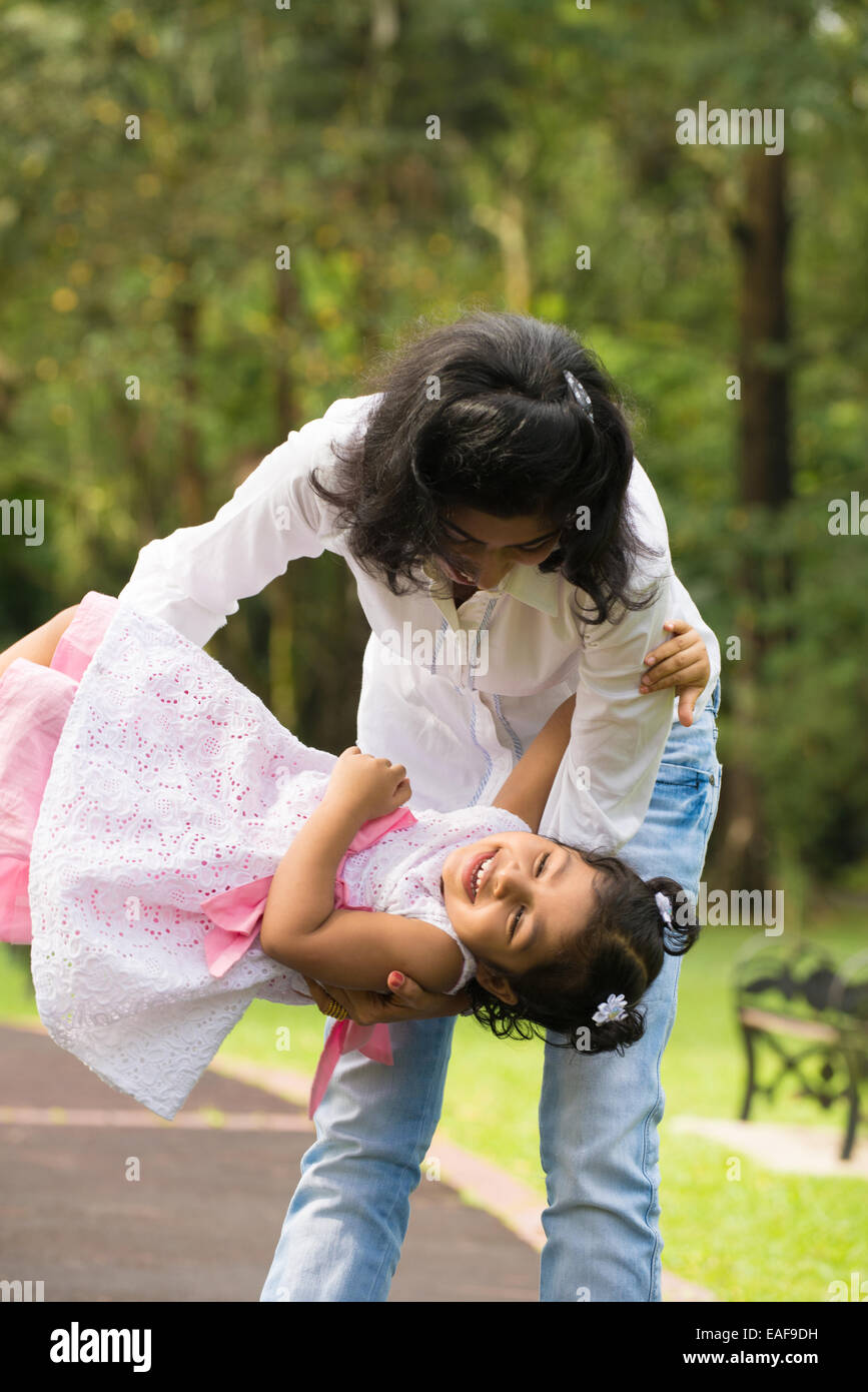 Happy Indian Mother And Daughter Playing In The Park Lifestyle Image