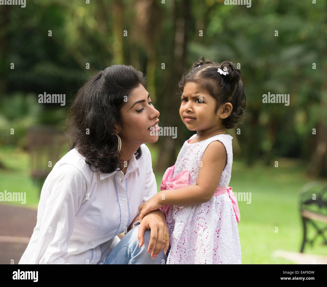 Happy Indian mother and daughter playing in the park. Lifestyle image ...