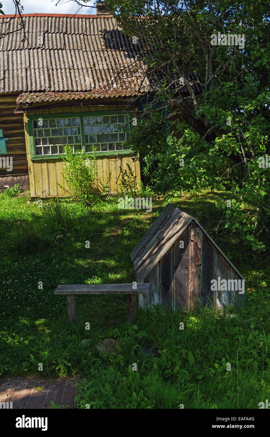 Village house. Old well with bench Stock Photo - Alamy