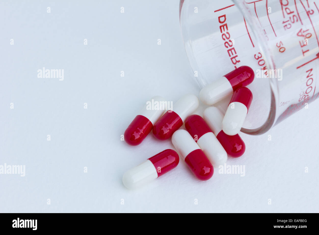capsules with measuring glass isolated on a white background Stock ...