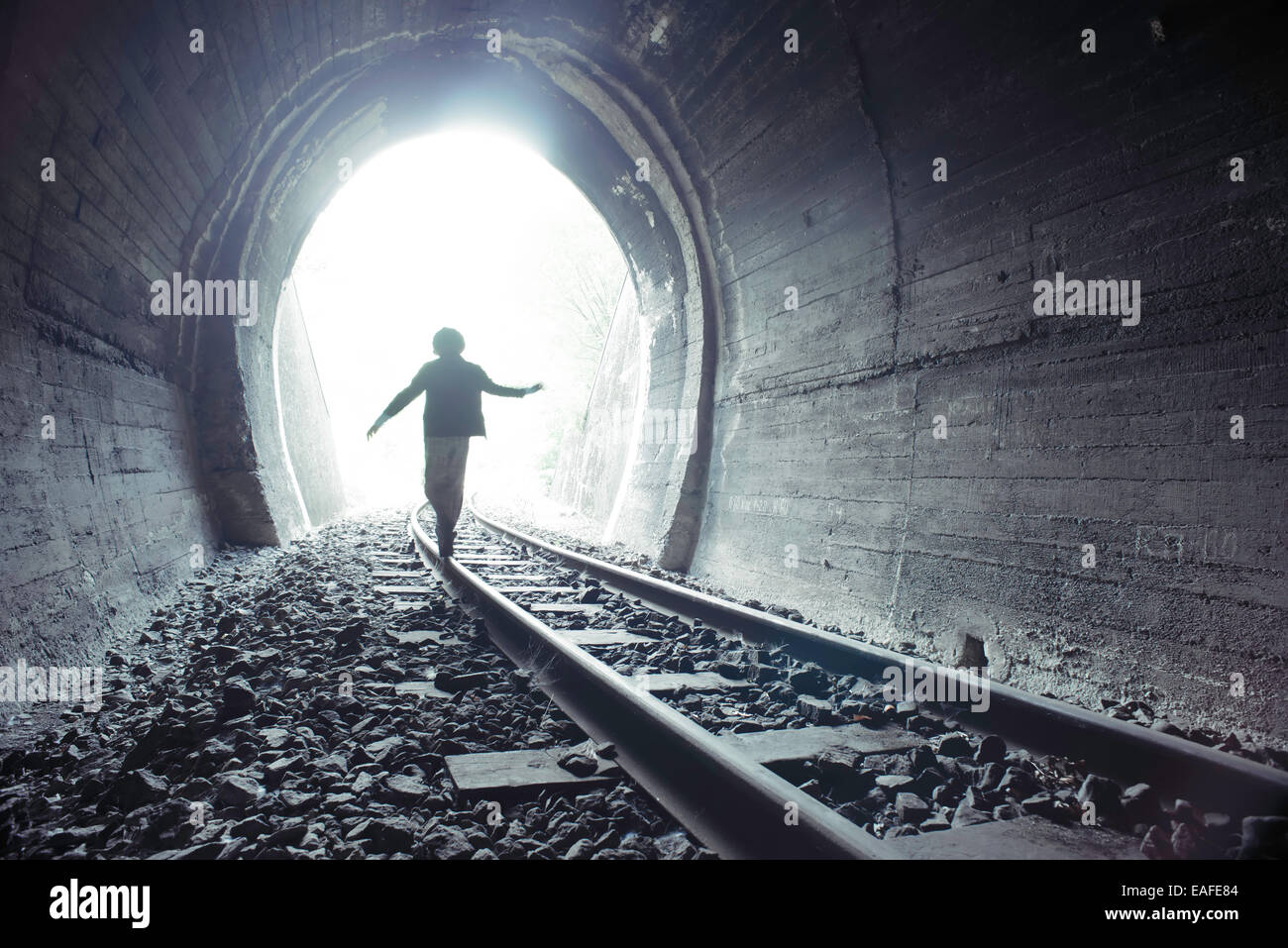 Child walking in railway tunnel. Vintage clothes Stock Photo - Alamy