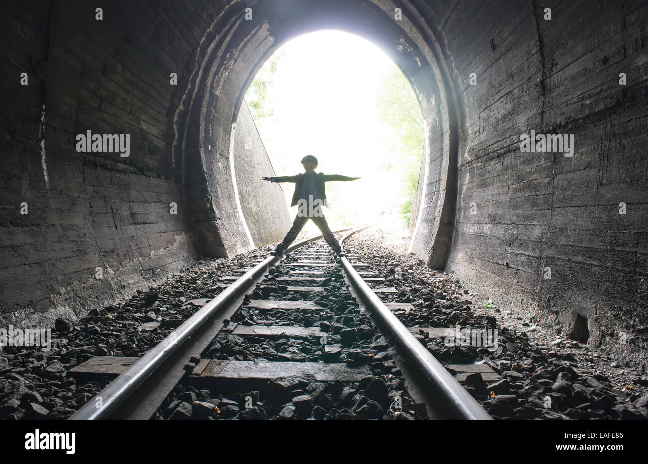 Child walking in railway tunnel. Vintage clothes Stock Photo - Alamy