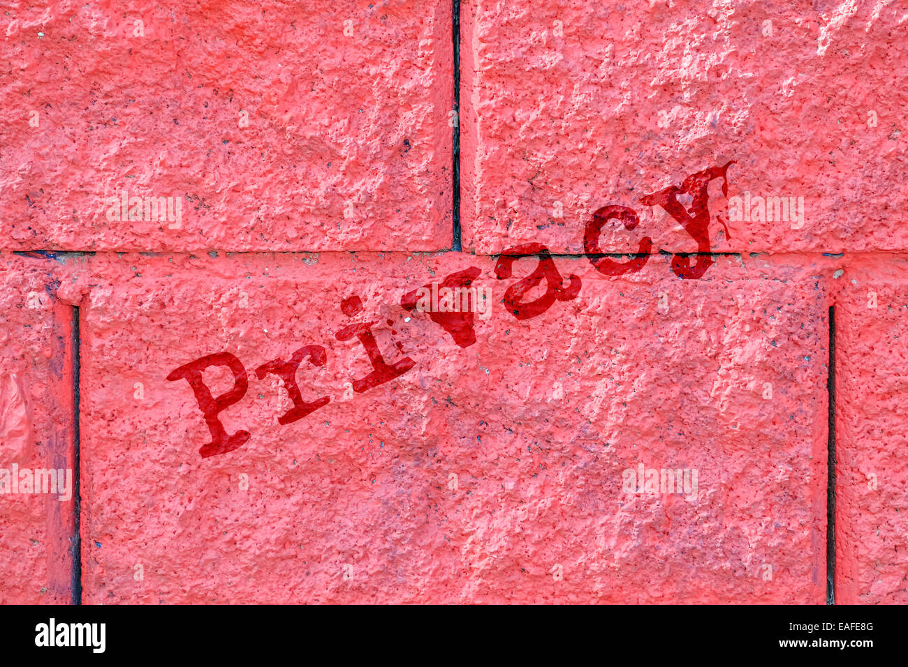 Brick wall with a written warning for privacy Stock Photo - Alamy