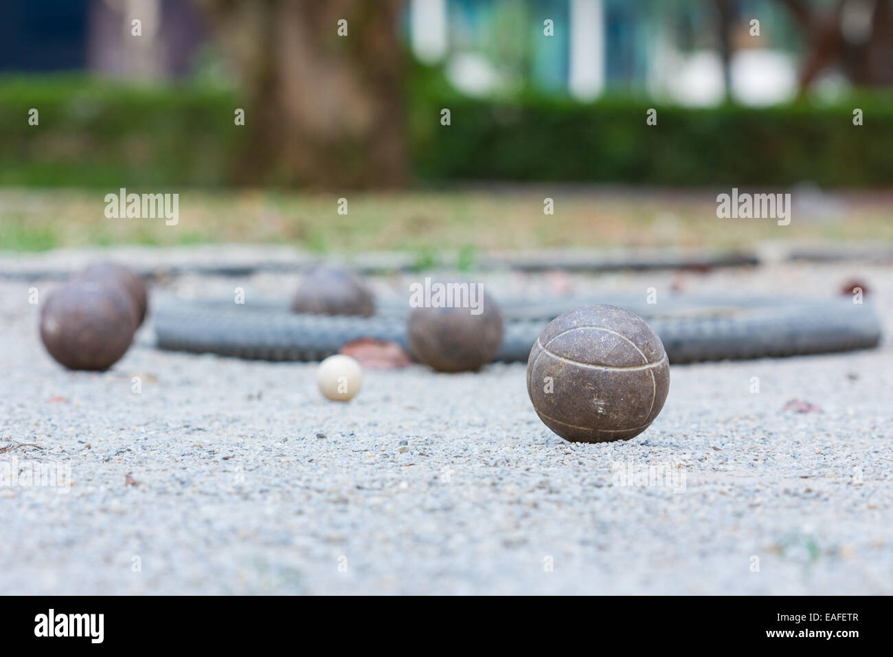Five rusty old petanque balls and the small white jack on petanque ...