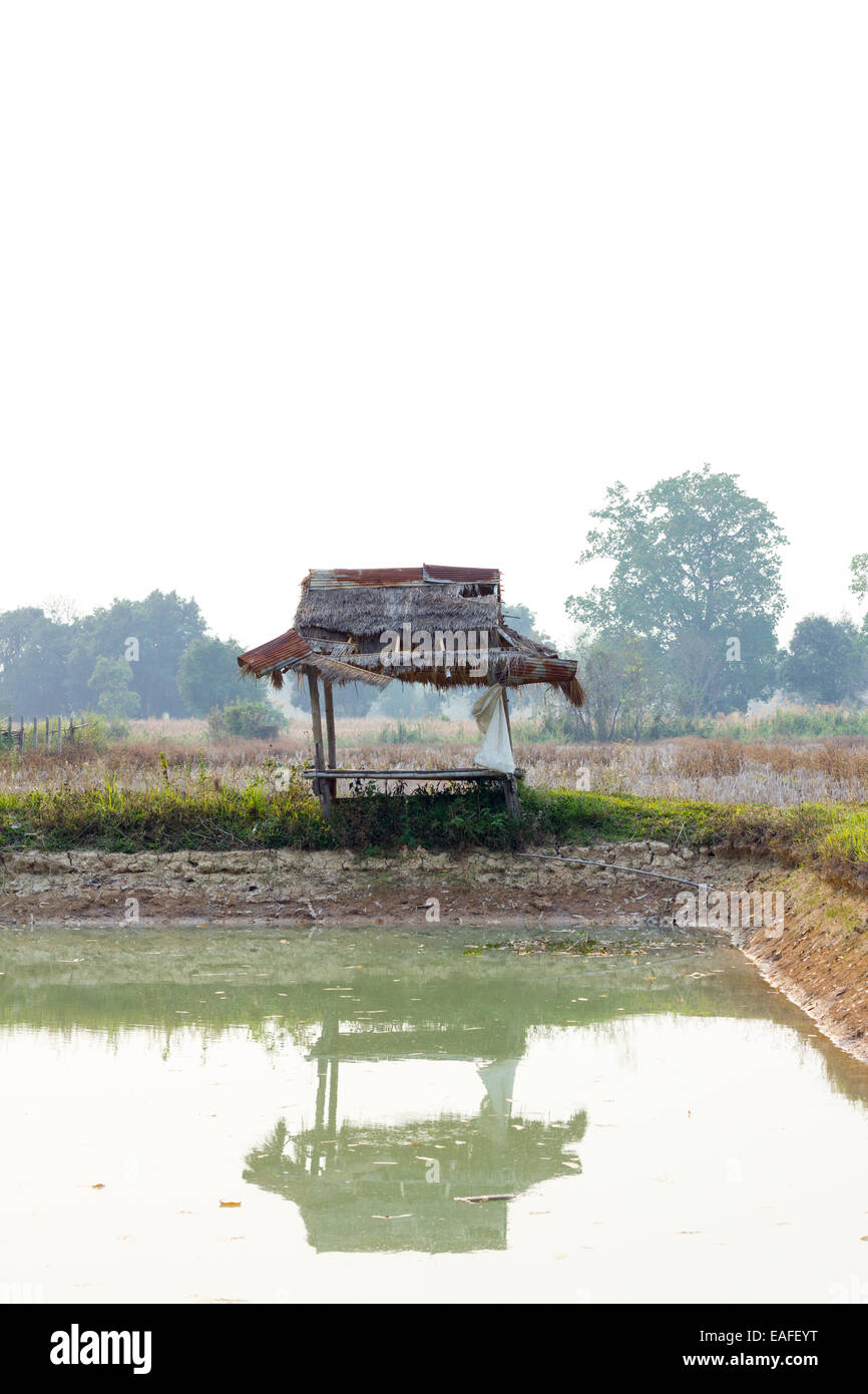 The fishing hut along the fish pond with reflection Stock Photo - Alamy