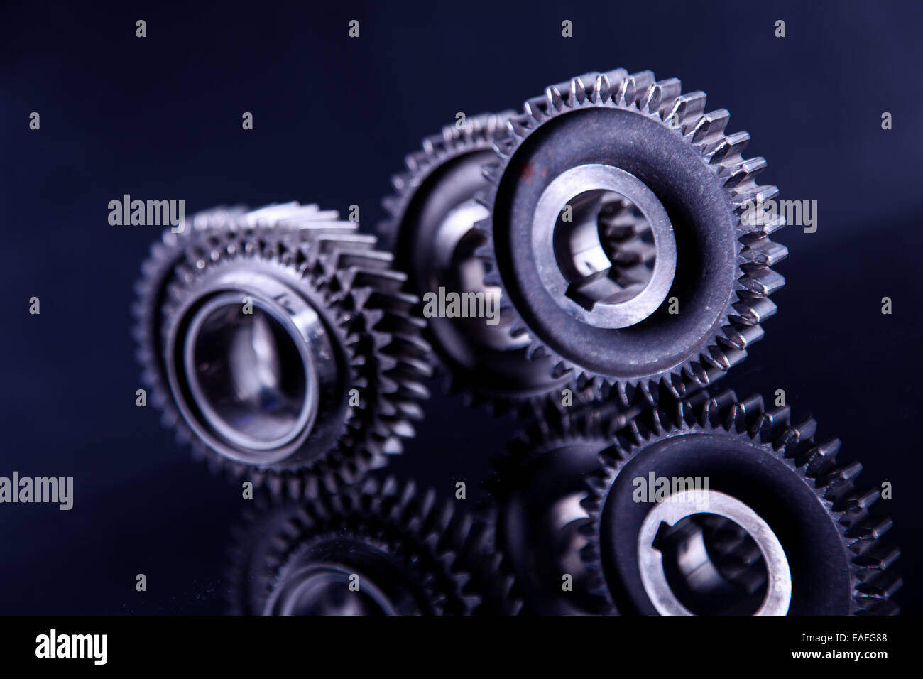 Big metal gears on glossy black background Stock Photo - Alamy