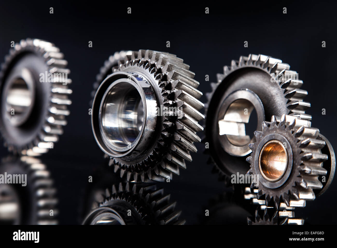 Big metal gears on glossy black background Stock Photo - Alamy
