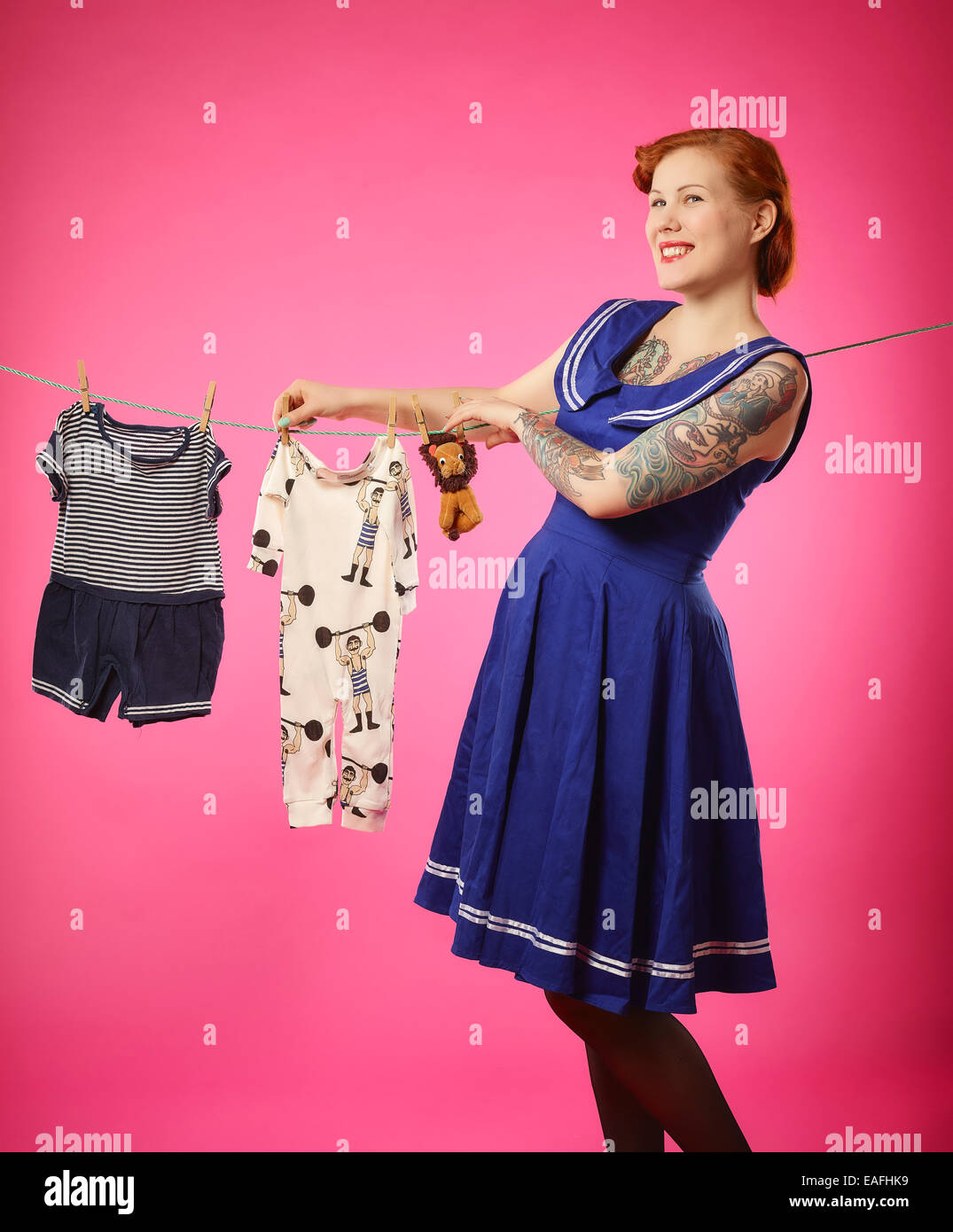 Girl hang up the clothes hi-res stock photography and images - Alamy